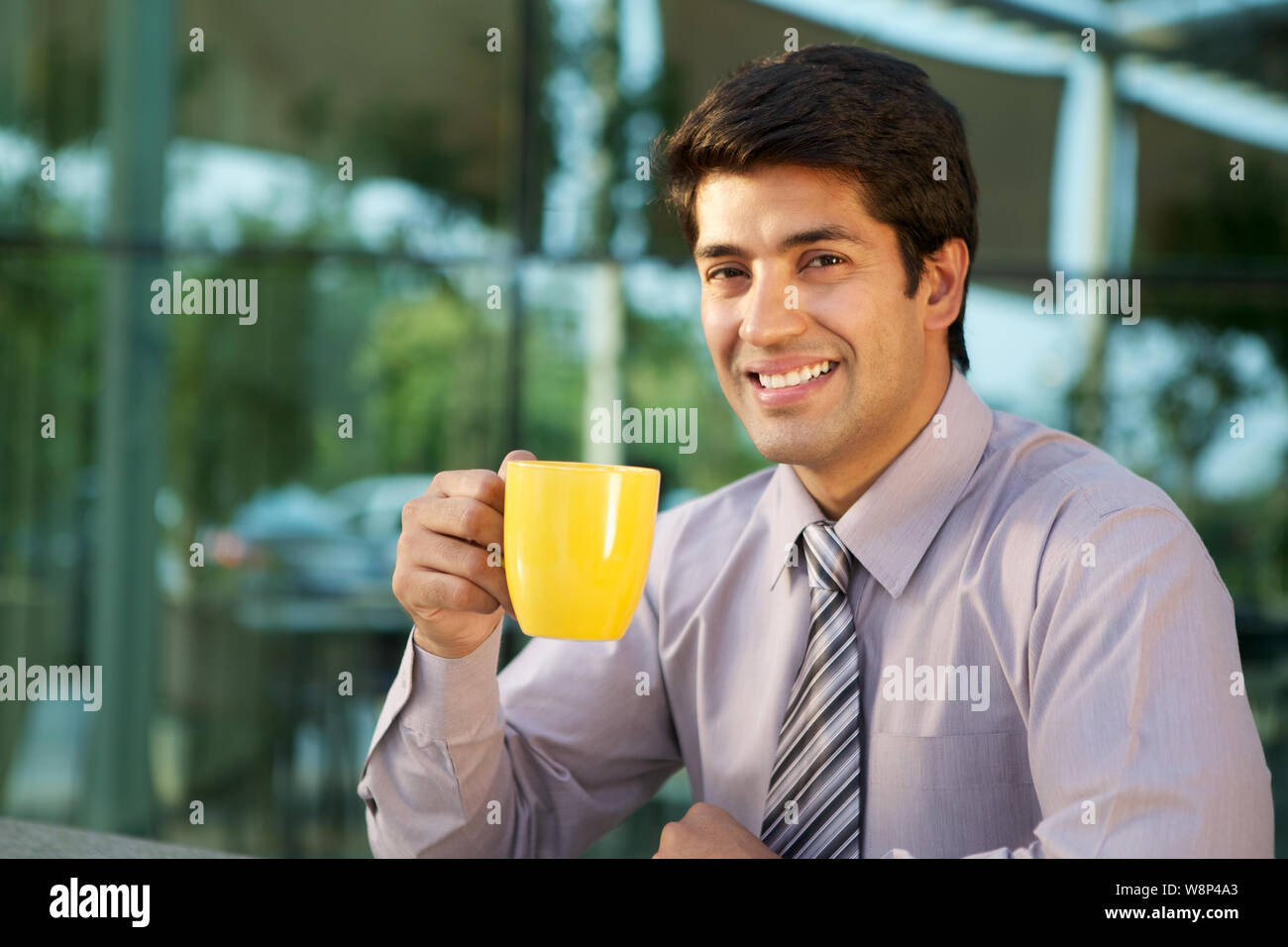 Businessman drinking coffee smiling camera hi-res stock photography and ...