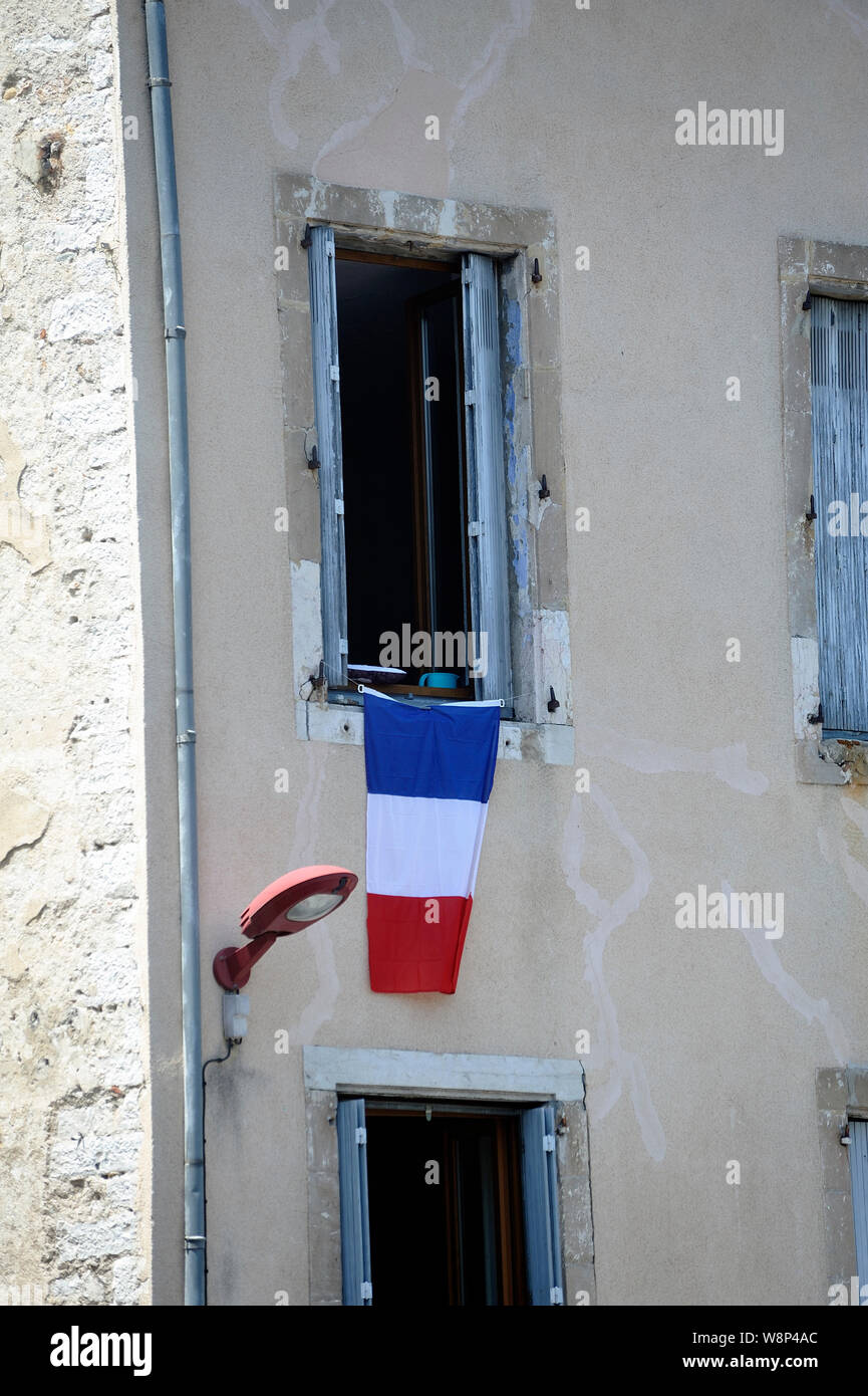 French flag hanging on a window in honor of the passage of the Tour de ...