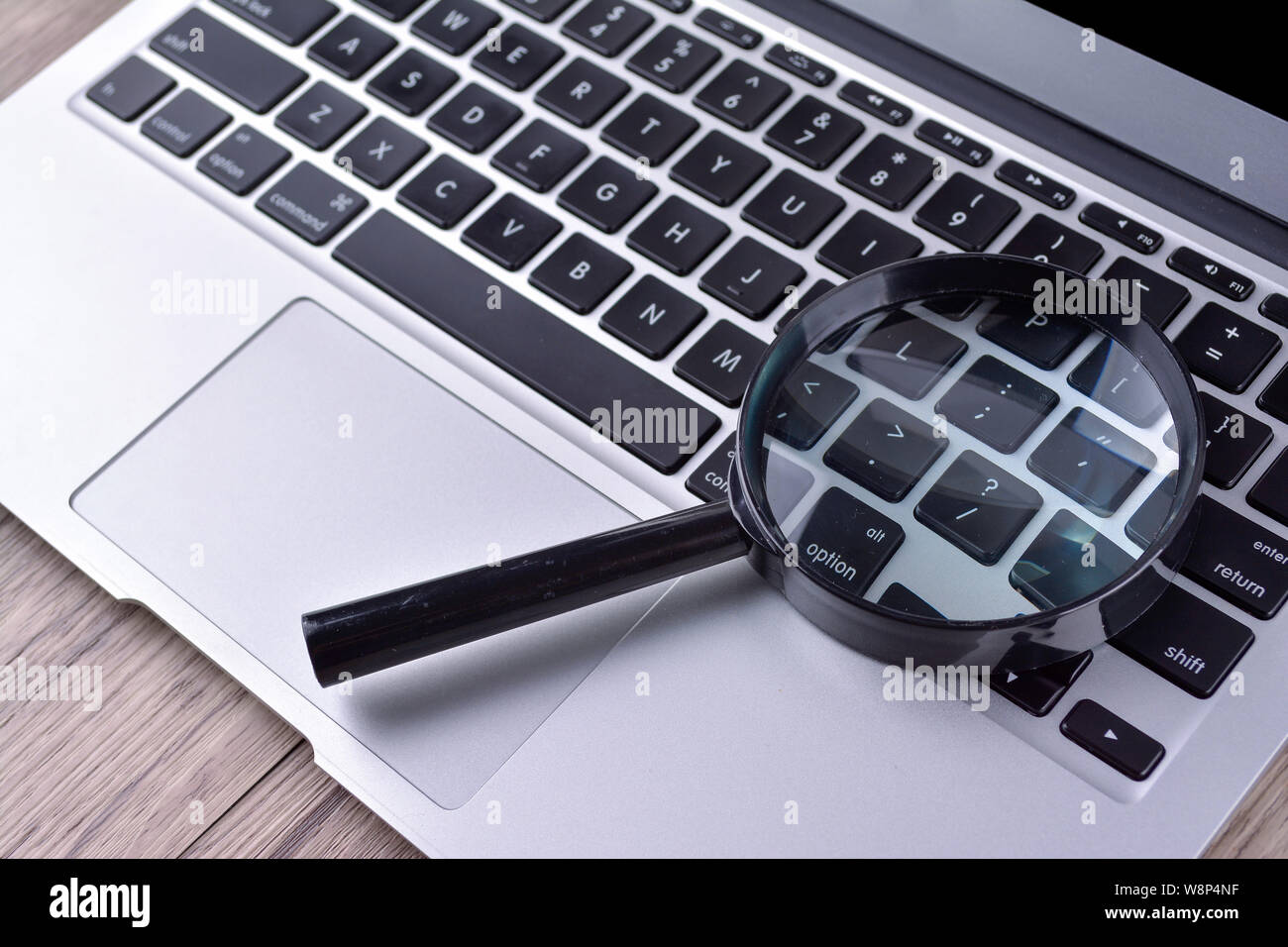 Laptop computer with magnifying glass, concept of search Stock Photo ...