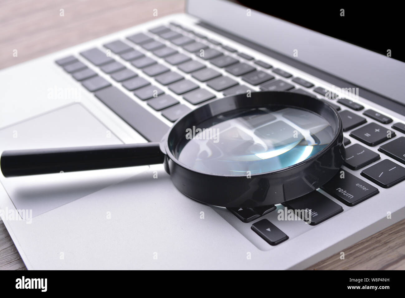 Laptop computer with magnifying glass, concept of search Stock Photo ...