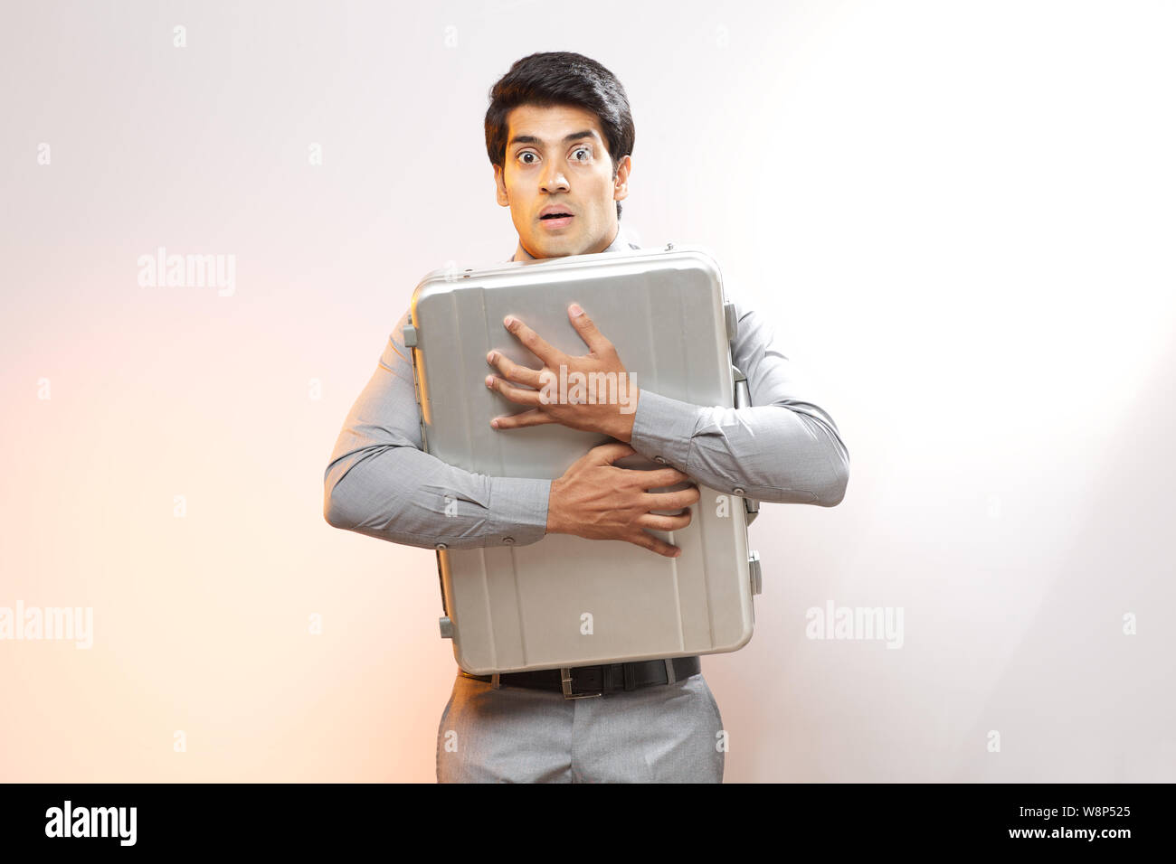 Businessman hugging a briefcase Stock Photo - Alamy