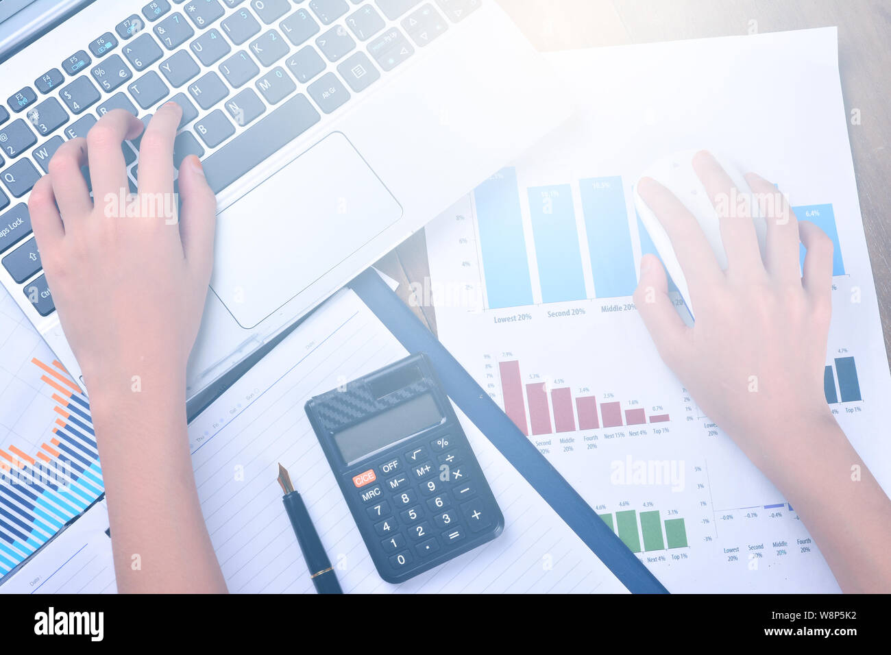 Hand on keyboard and mouse with graph, chart on wooden table Stock ...