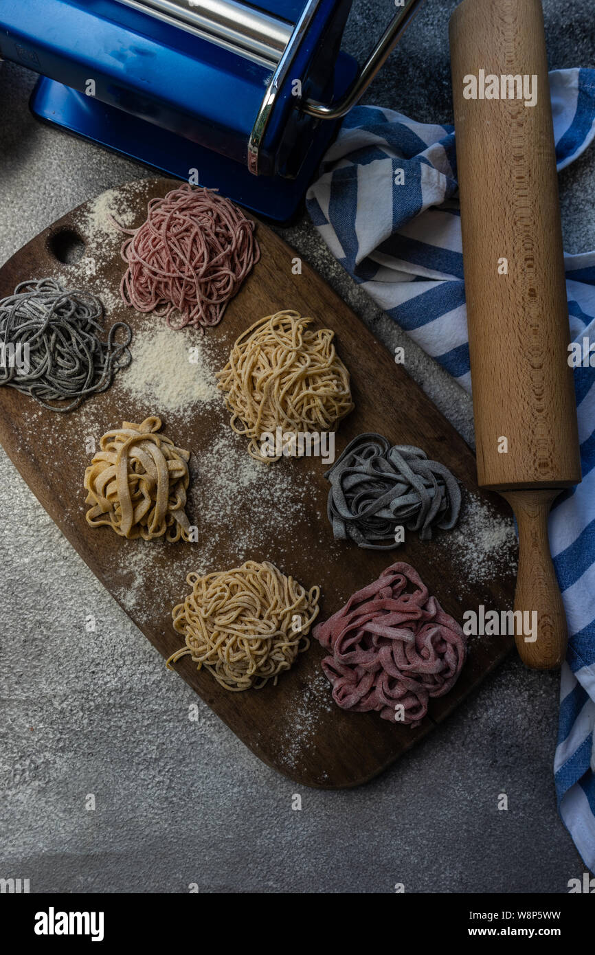 Cooking concept with italian homemade pasta variety on concrete ...