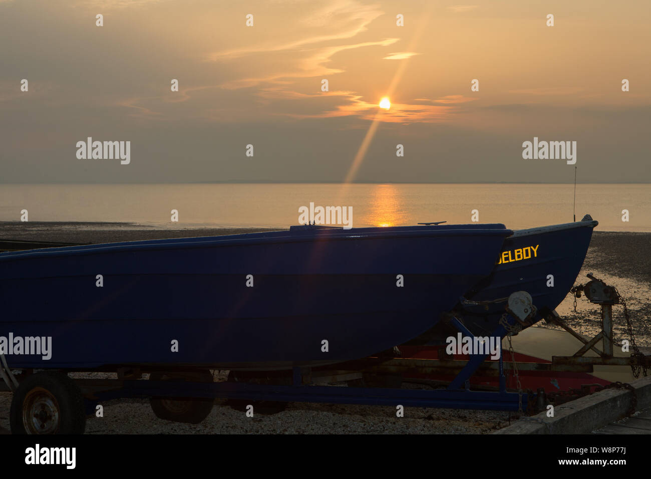Cloudy sunset over sailing boats hi-res stock photography and images ...