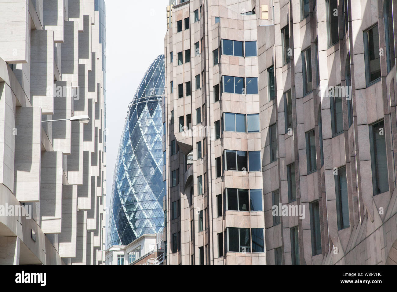 The Gherkin Building in between two skyscrapers, London Stock Photo - Alamy
