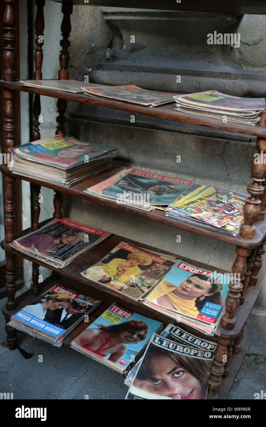 Old magazines on an old wooden rack for sale, Via Nazionale, Cortona ...