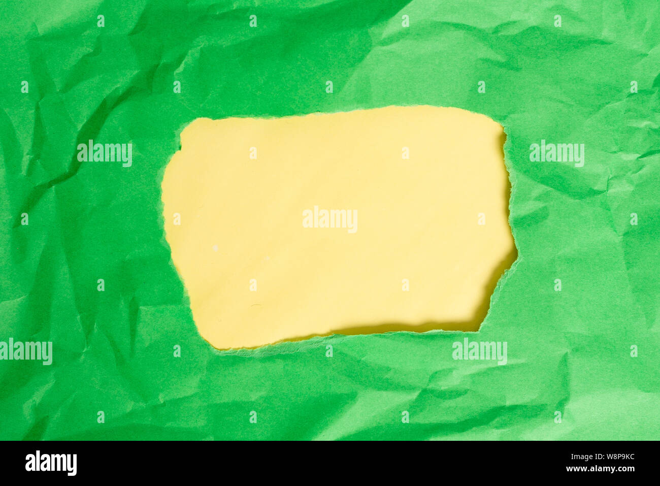 Green crumpled ripped colored paper sheet centre torn colorful ...