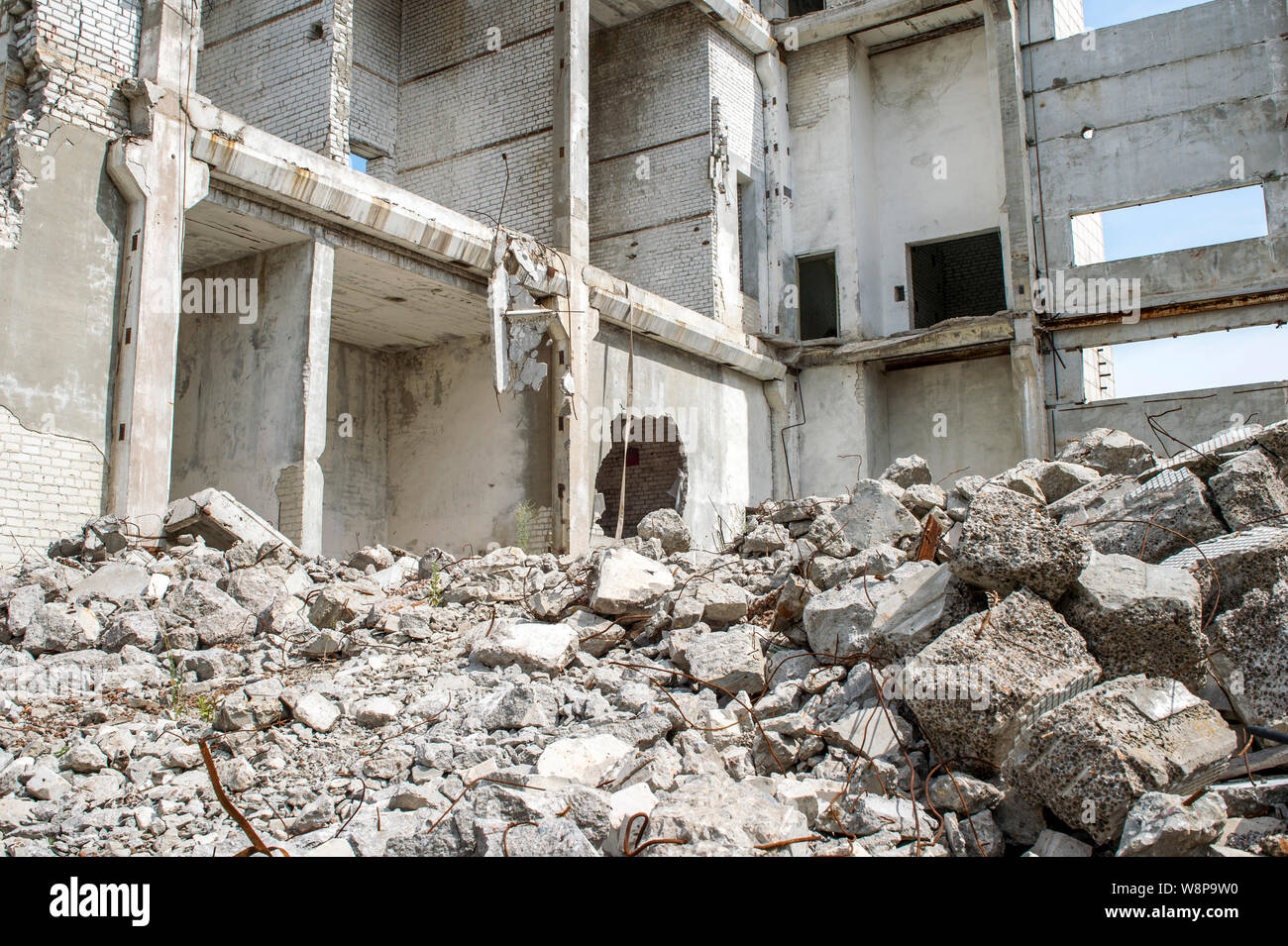 Concrete gray debris close-up against the remains of the destroyed ...