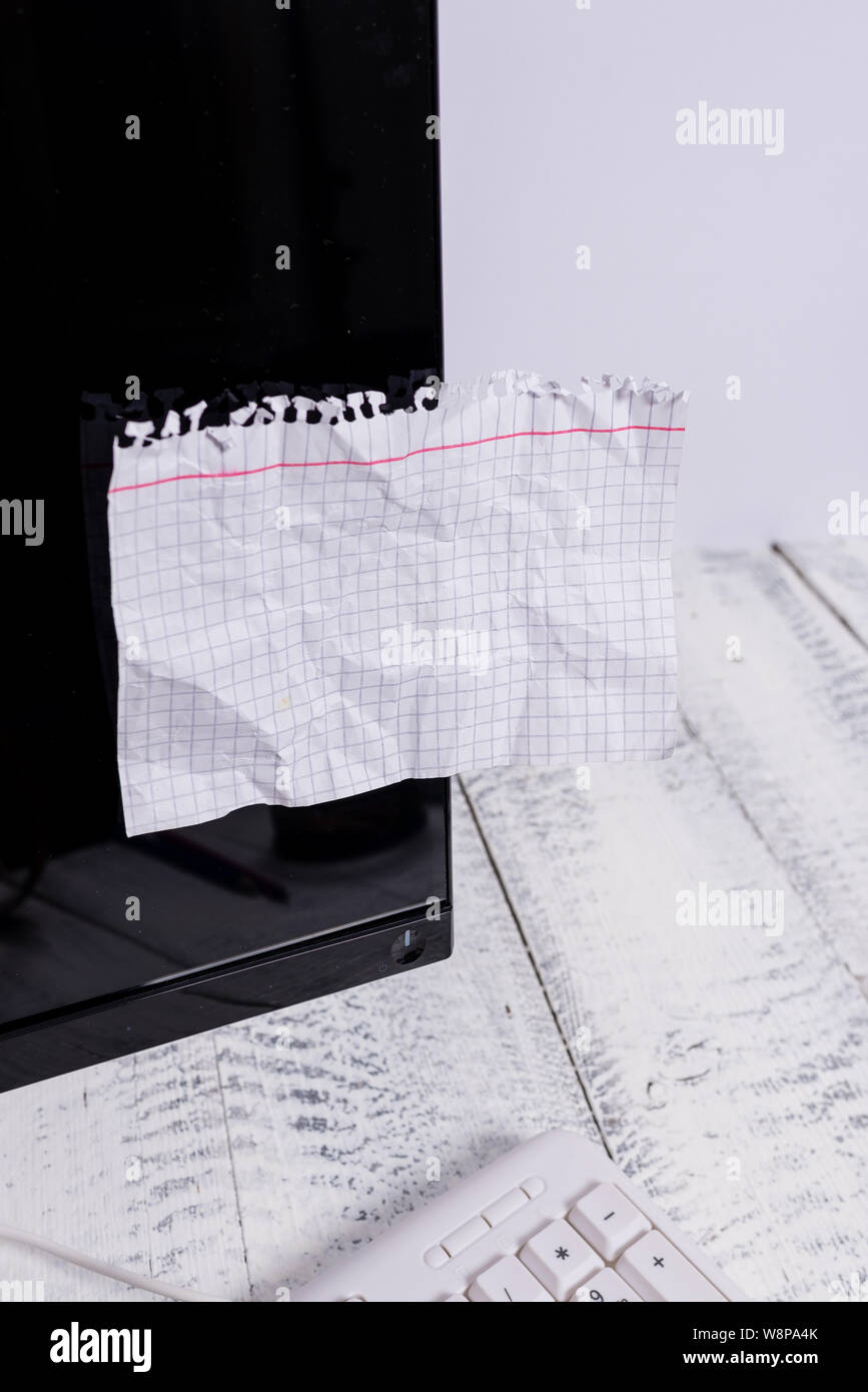 Notation paper taped to black computer monitor screen near white ...
