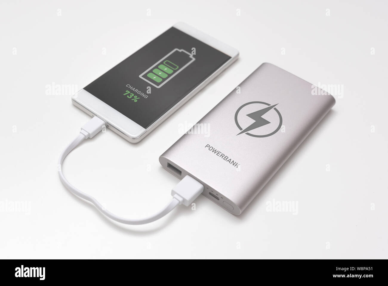 USB charger plugged in to smart phone. Power bank, mobile phone battery ...