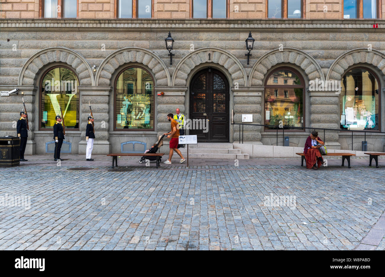 Stockholm, Sweden -- July 18, 2019. A man pushing a baby carriage walks ...
