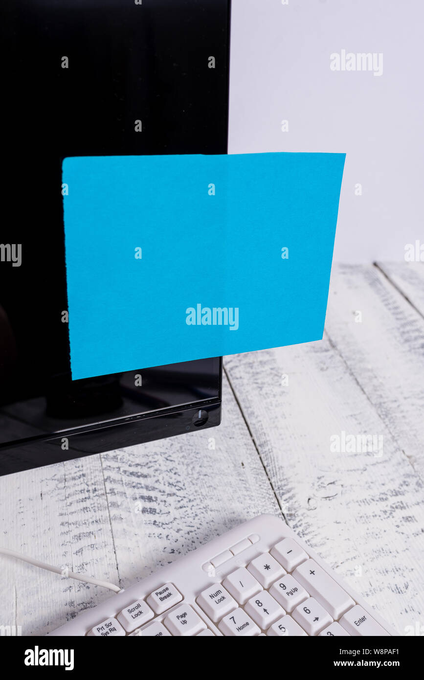 Notation paper taped to black computer monitor screen near white ...