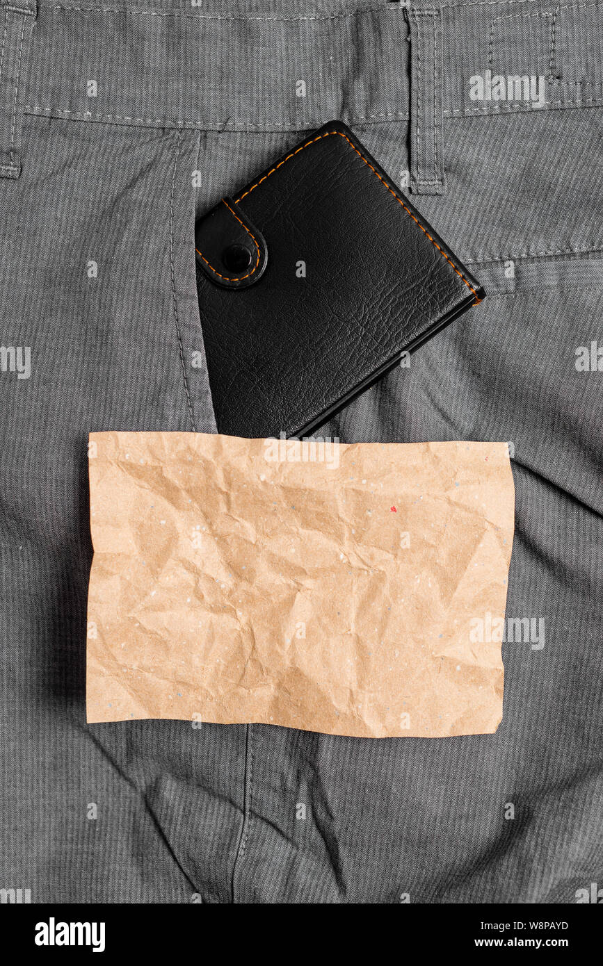 Small little wallet inside man trousers front pocket near notation ...