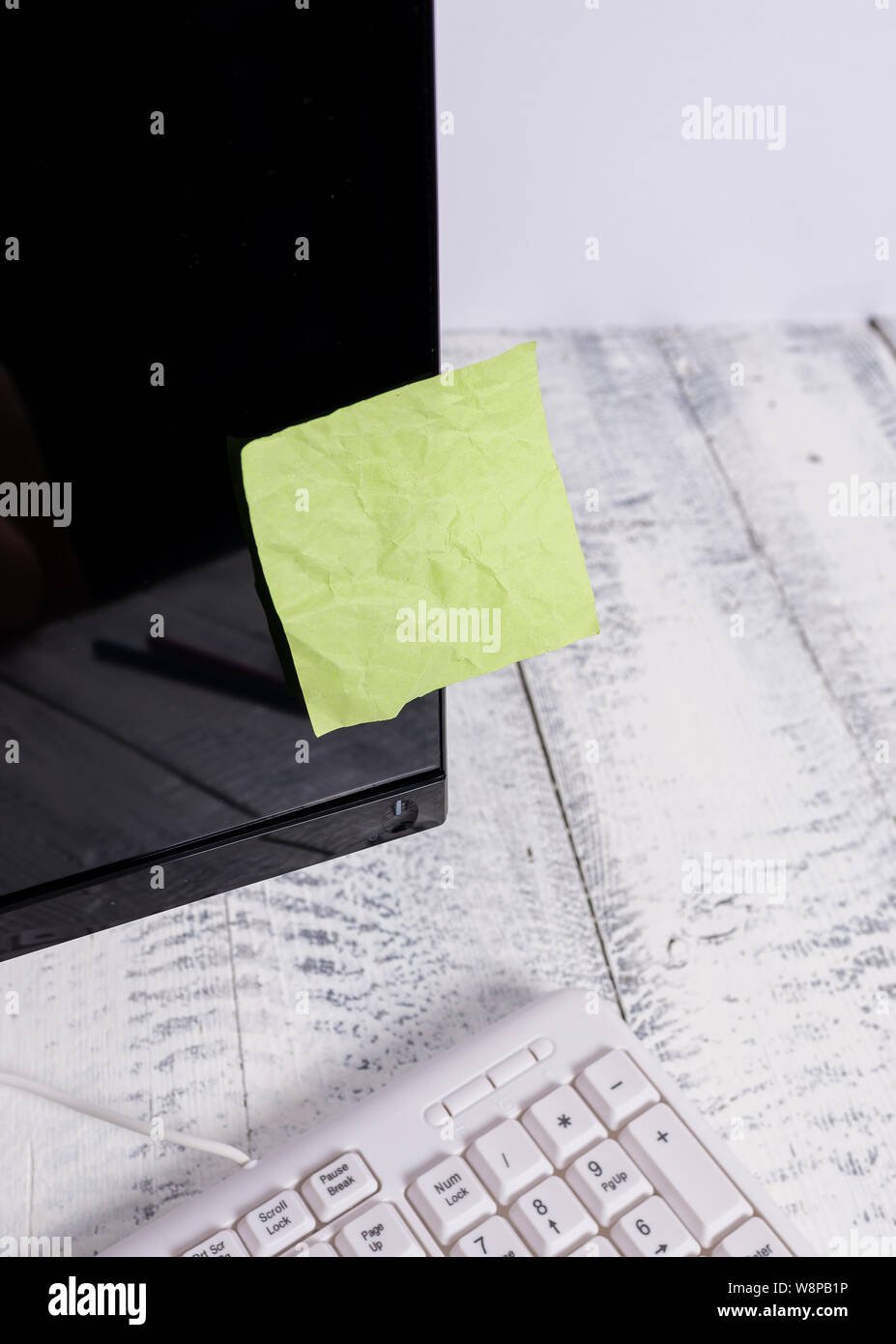 Notation paper taped to black computer monitor screen near white ...