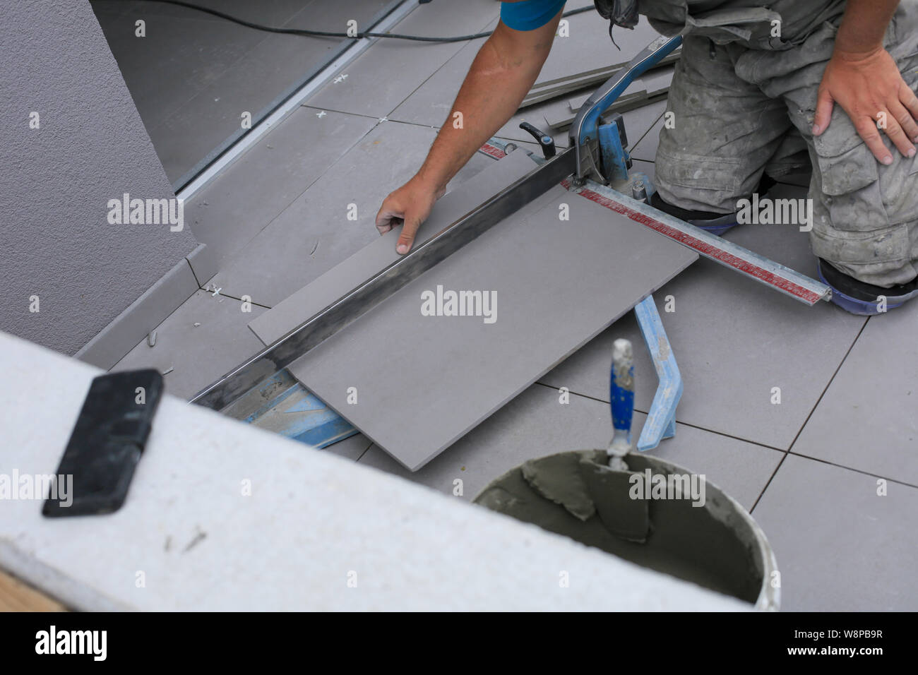 Installing tiles applying mortar wall hi-res stock photography and ...
