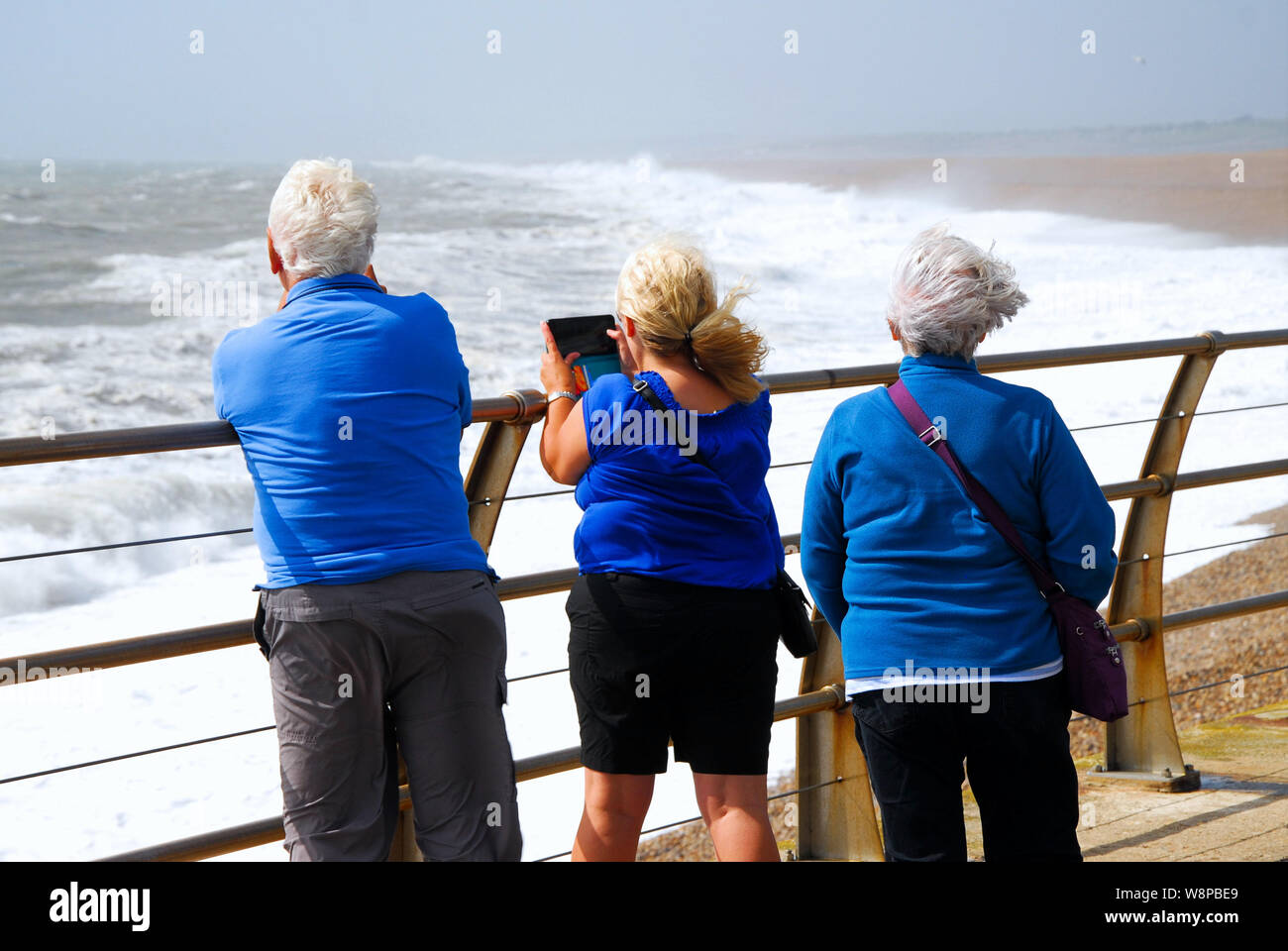 Huge waves tower over men hi-res stock photography and images - Alamy