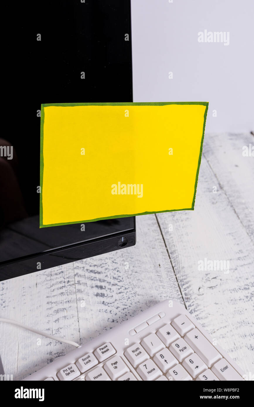 Notation paper taped to black computer monitor screen near white ...