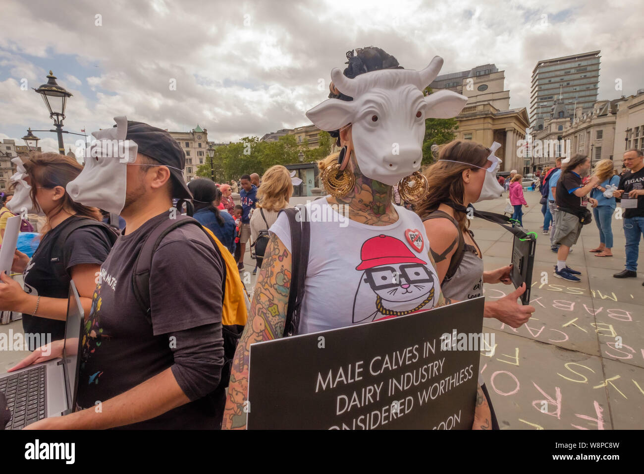 London, UK. 10th August 2019. Protesters stand in a small block wearing ...