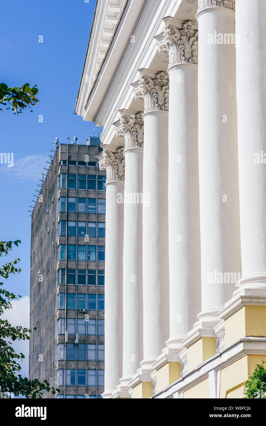 Front of Old Buildig with Columns and Skyscrapper on Background ...