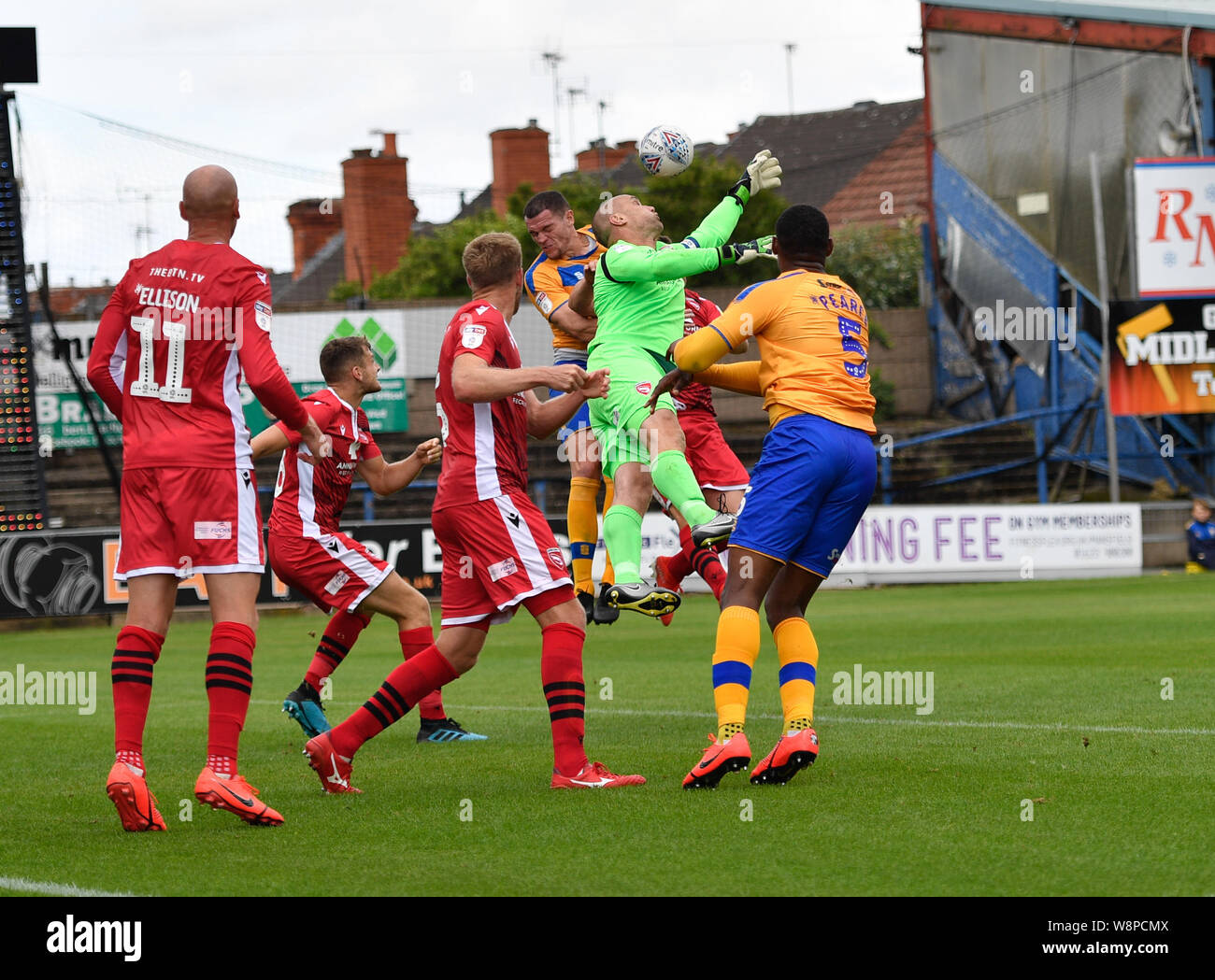 Morecambe goalkeeper Barry Roche punches clear under pressure from ...