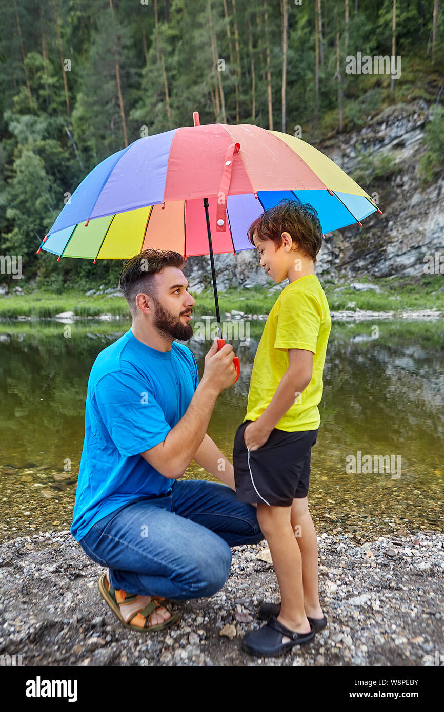 Father and son are spending fathers day in the countryside near river ...