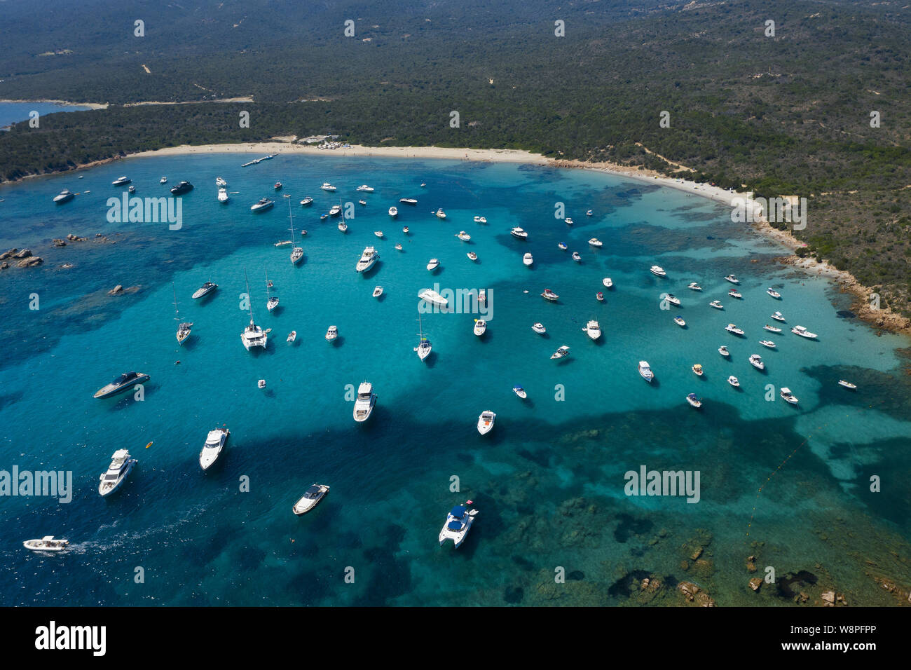 View from above, stunning aerial view of a beautiful bay full of boats ...