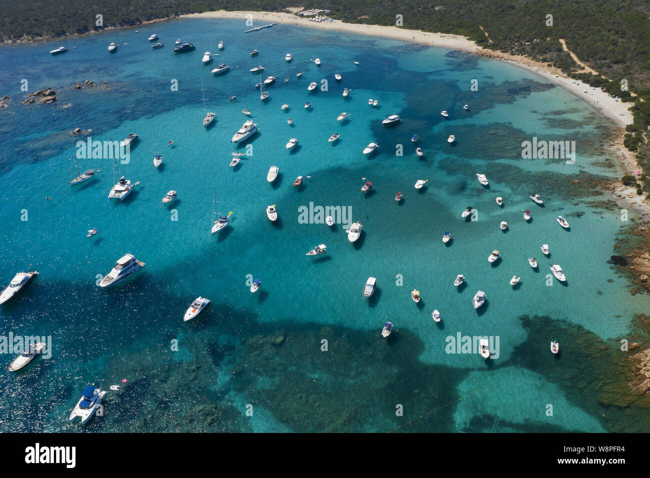 View from above, stunning aerial view of a beautiful bay full of boats ...