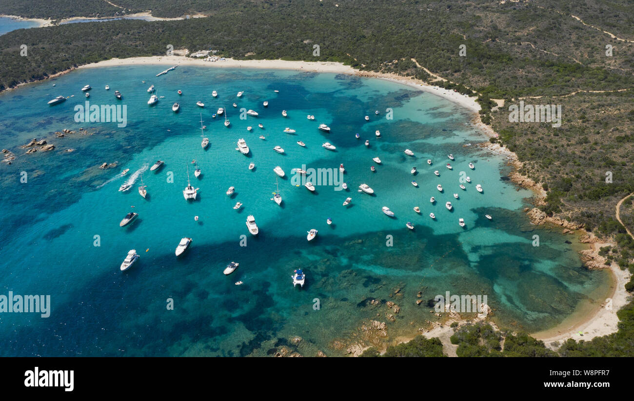 View from above, stunning aerial view of a beautiful bay full of boats ...