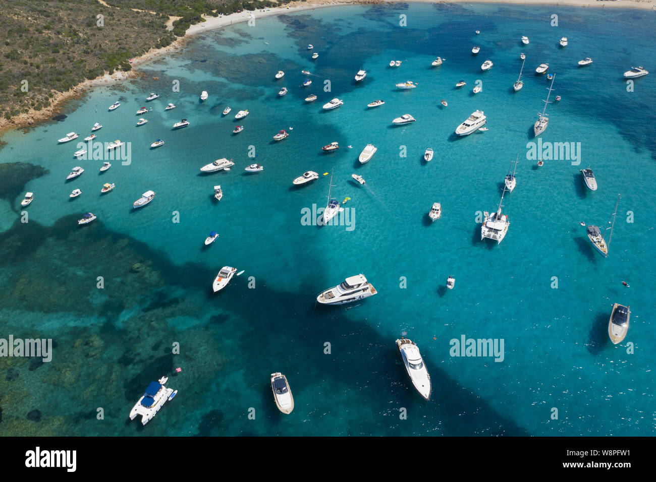 View from above, stunning aerial view of a beautiful bay full of boats ...