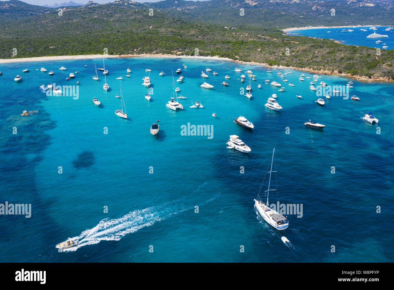 View from above, stunning aerial view of a beautiful bay full of boats ...