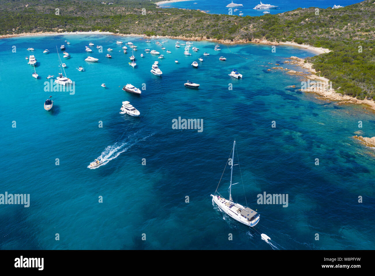 View from above, stunning aerial view of a beautiful bay full of boats ...