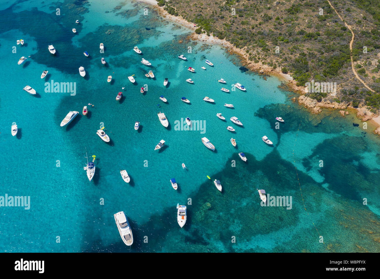 View from above, stunning aerial view of a beautiful bay full of boats ...