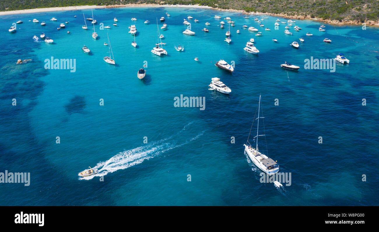 View from above, stunning aerial view of a beautiful bay full of boats ...