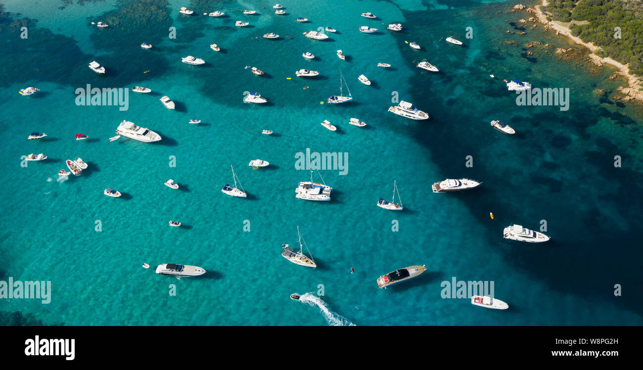 View from above, stunning aerial view of a beautiful bay full of boats ...