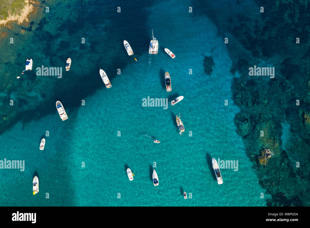 View from above, stunning aerial view of a beautiful bay full of boats ...
