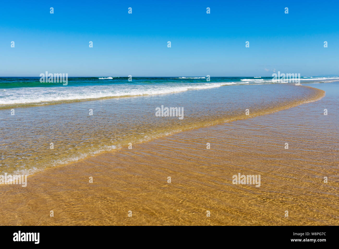 Waves rolling on shore sunny hi-res stock photography and images - Alamy