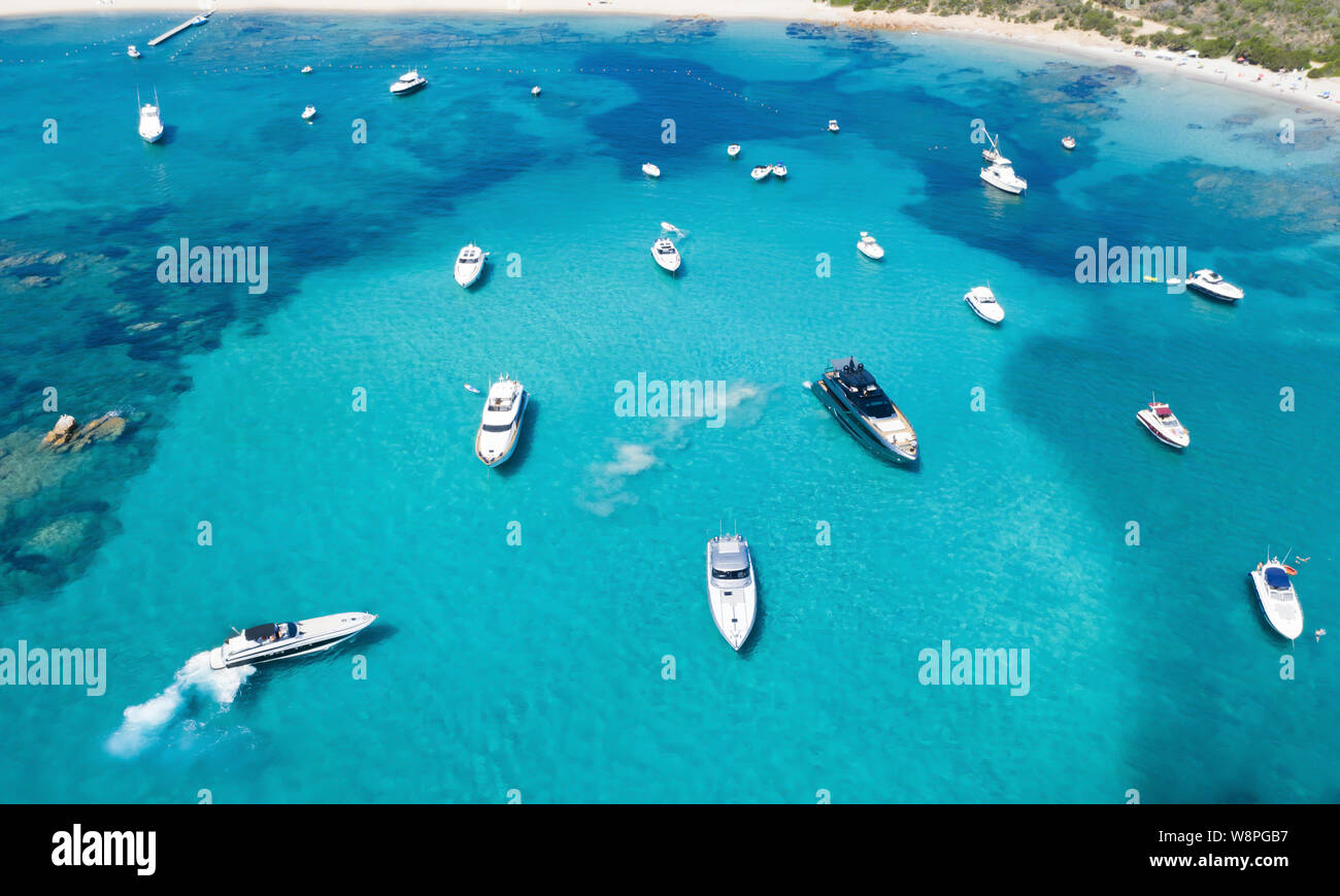 View from above, stunning aerial view of a beautiful bay full of boats ...