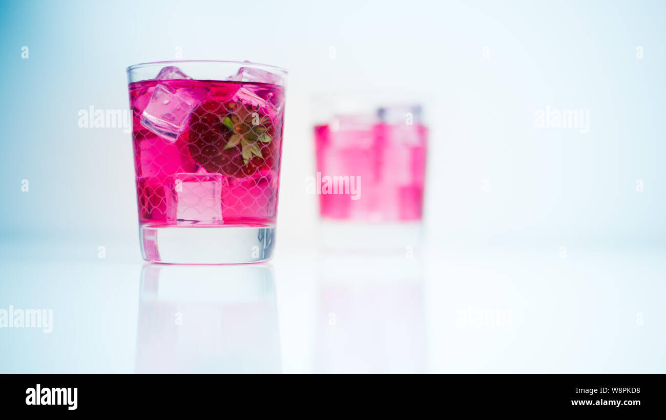 Strawberry and raspberry drink isolated on light blue background Stock ...