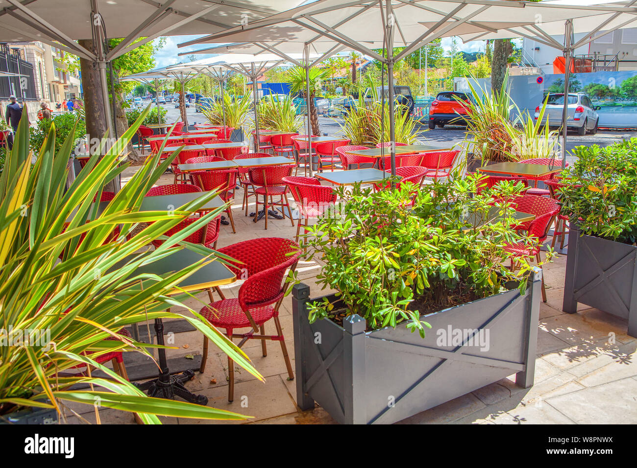 street restaurant terrace with flower pots Stock Photo - Alamy