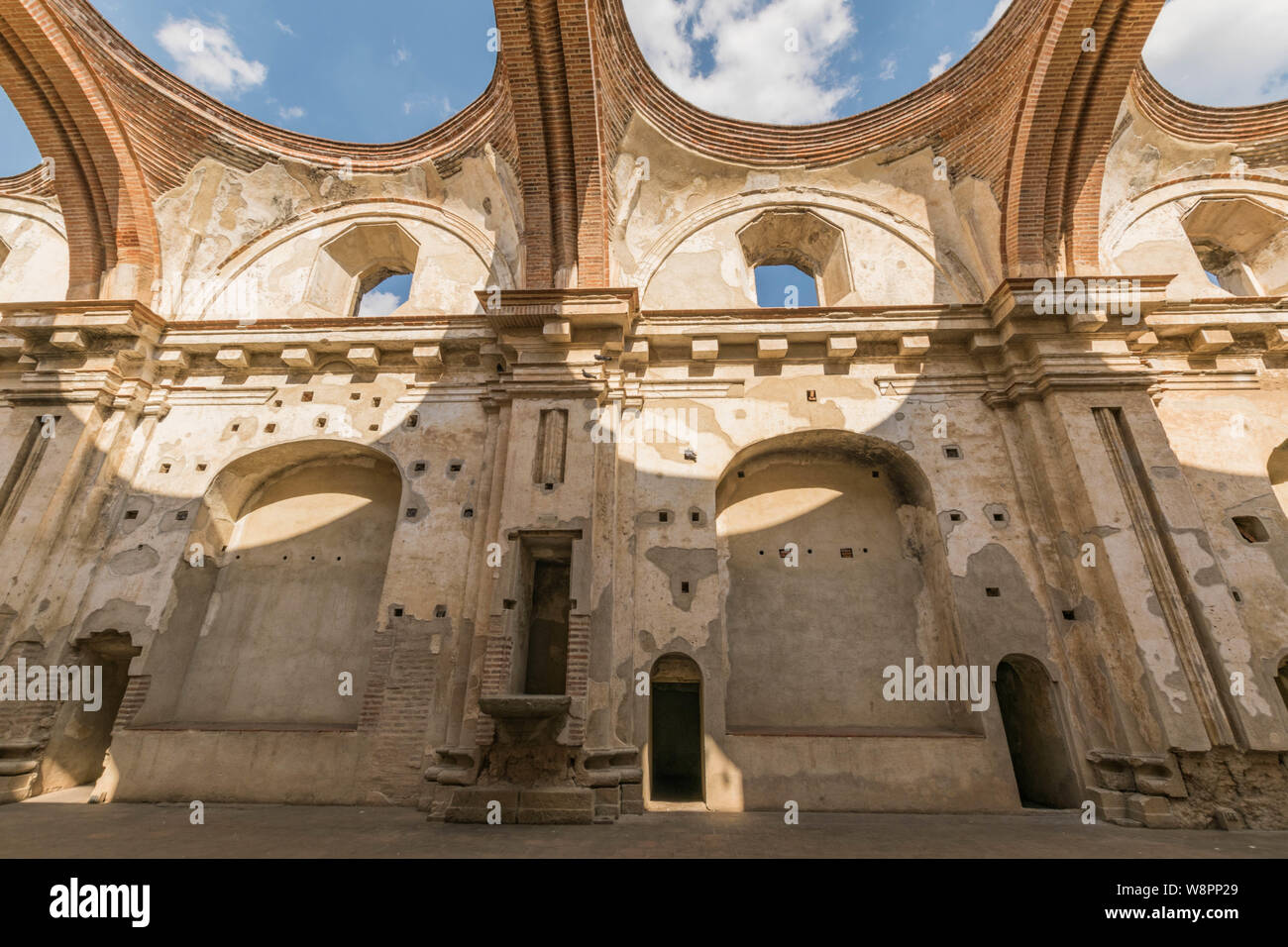 Stone architectural ruins with arches and sky, at the Antigua Guatemala ...