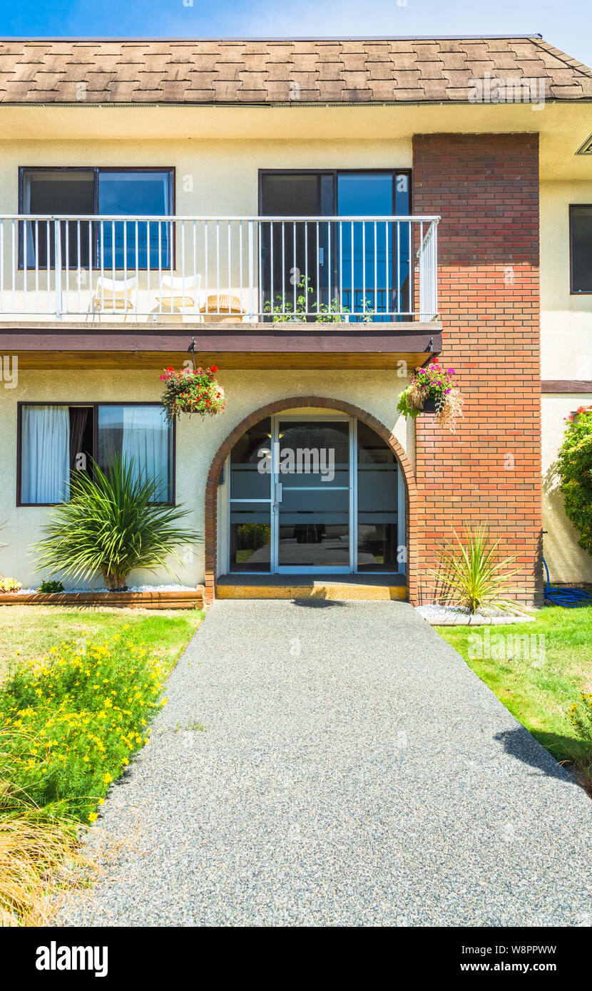 Main entrance of residential house with concrete pathway in front on ...