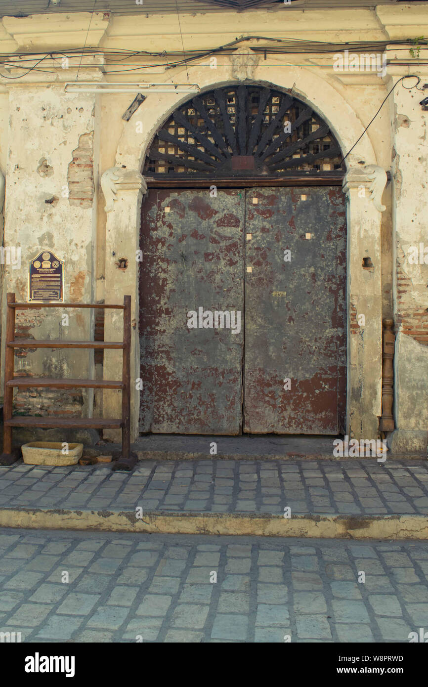JULY 14, 2019-VIGAN PHILIPPINES: Ancient dirty double door along the ... JULY 14, 2019-VIGAN PHILIPPINES: Ancient dirty double door along the ...