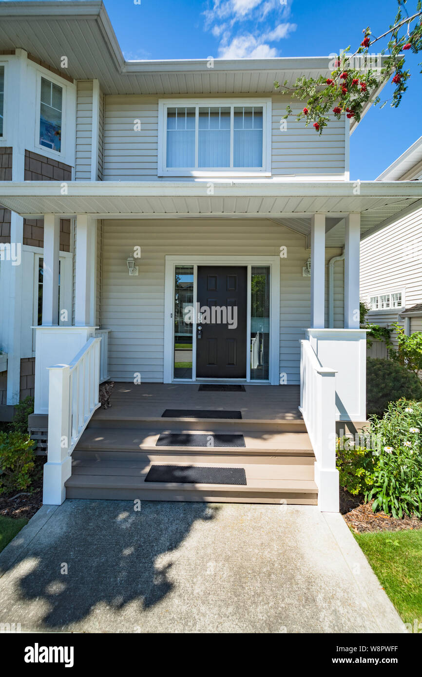 Main entrance of residential house with concrete pathway in front Stock ...