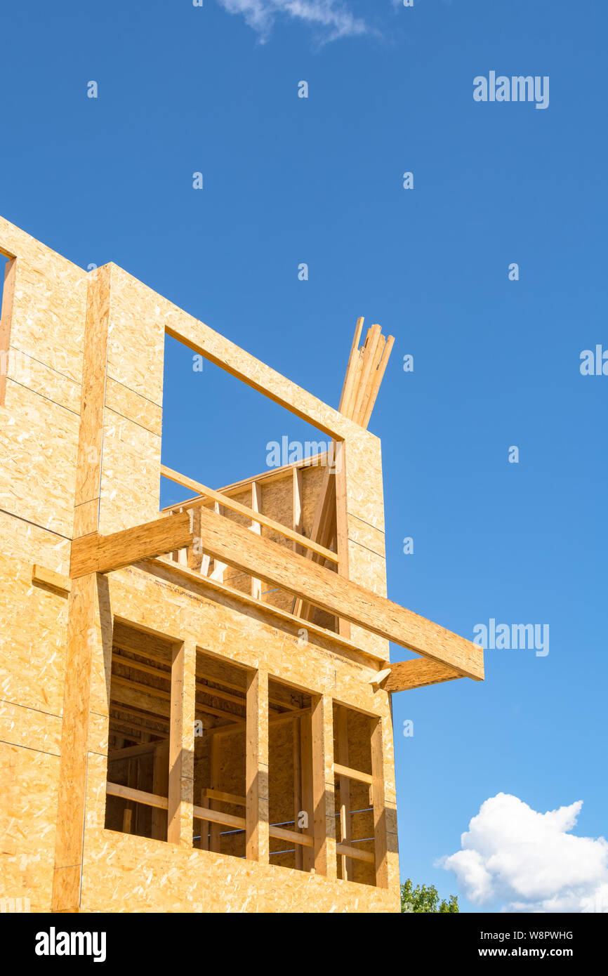 New residential building under construction on blue sky background ...