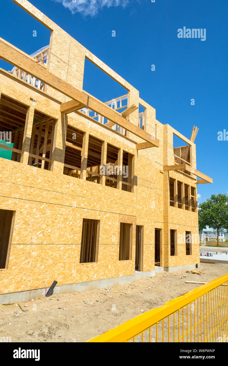 Low rise wooden framework of the building on concrete base Stock Photo ...