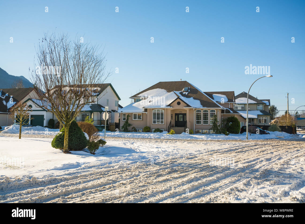 Street of residential houses in snow on winter season in suburb in ...