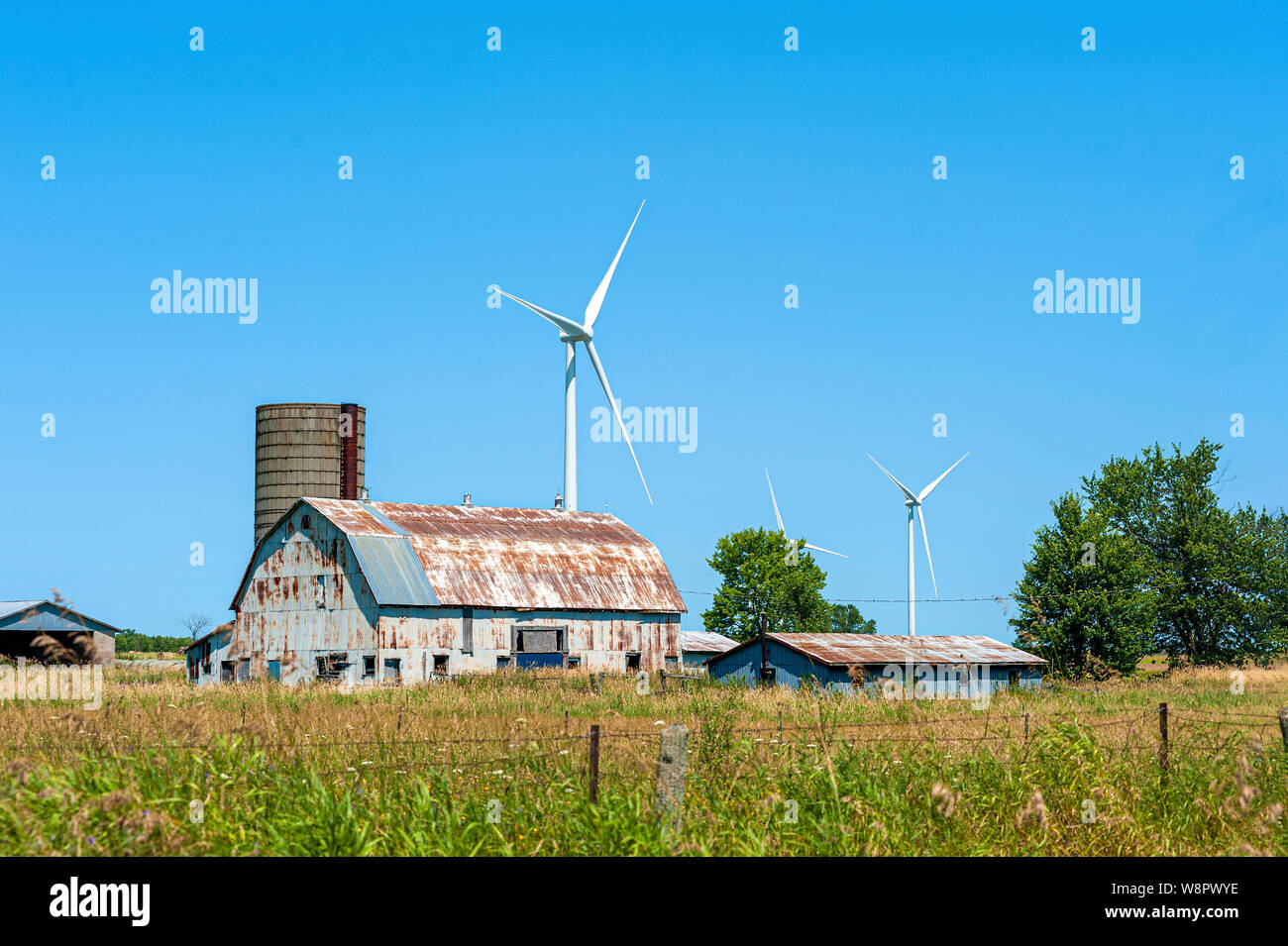 Wind turbines behind barn and silo Stock Photo - Alamy