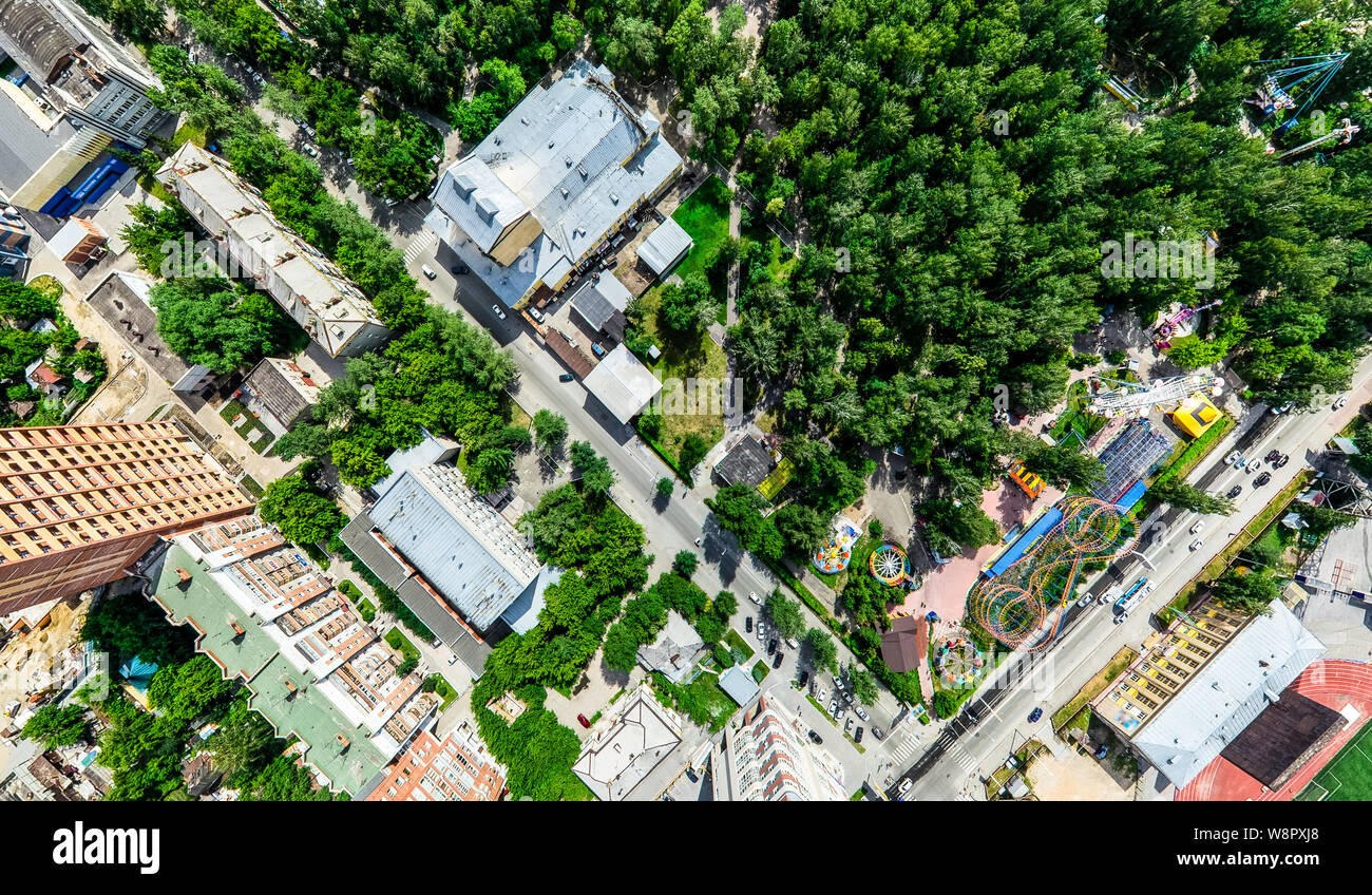 Aerial city view with crossroads and roads, houses, buildings, parks ...