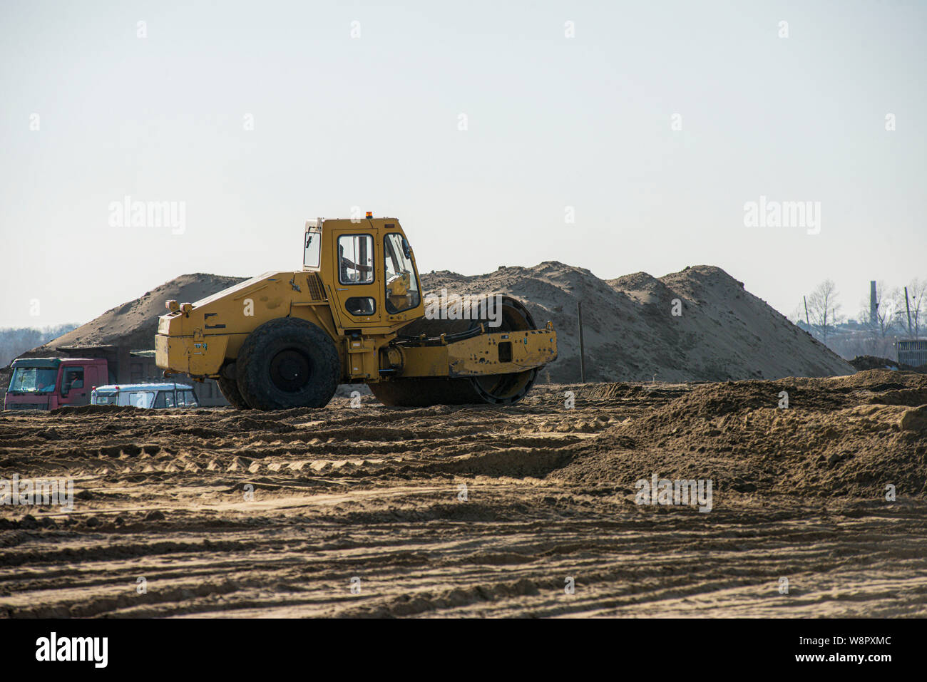heavy duty machinery working on highway construction site. Bulldozer ...