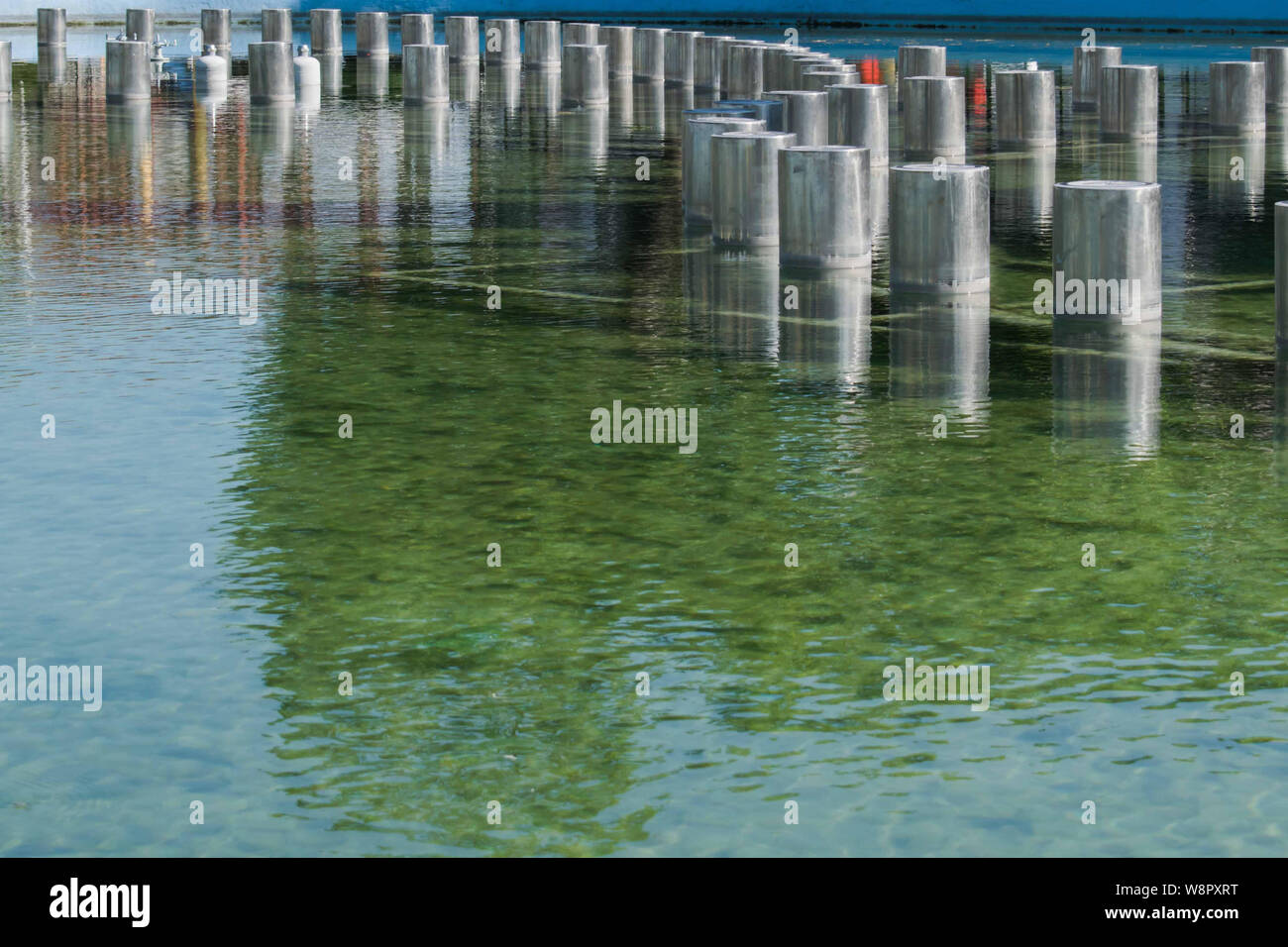 Silver cinder blocks arranged on a curved manner and placed at a water ...